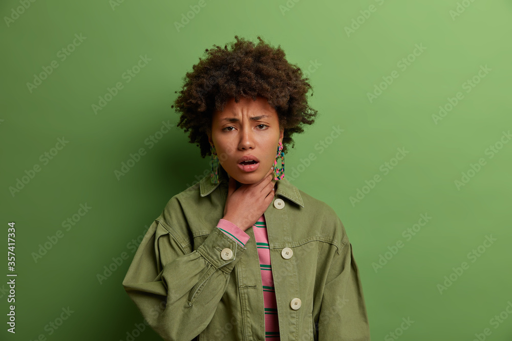 Unhappy dark skinned female model has terrible throat pain, suffers ...