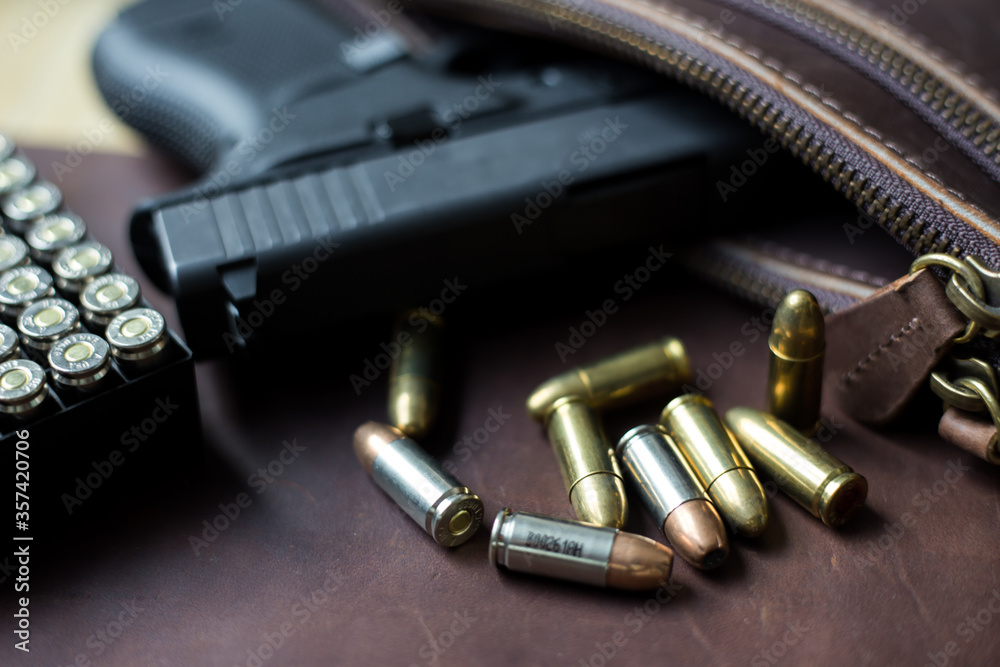9mm conceal polymer gun with fmj bullet in leather gun Stock Photo ...
