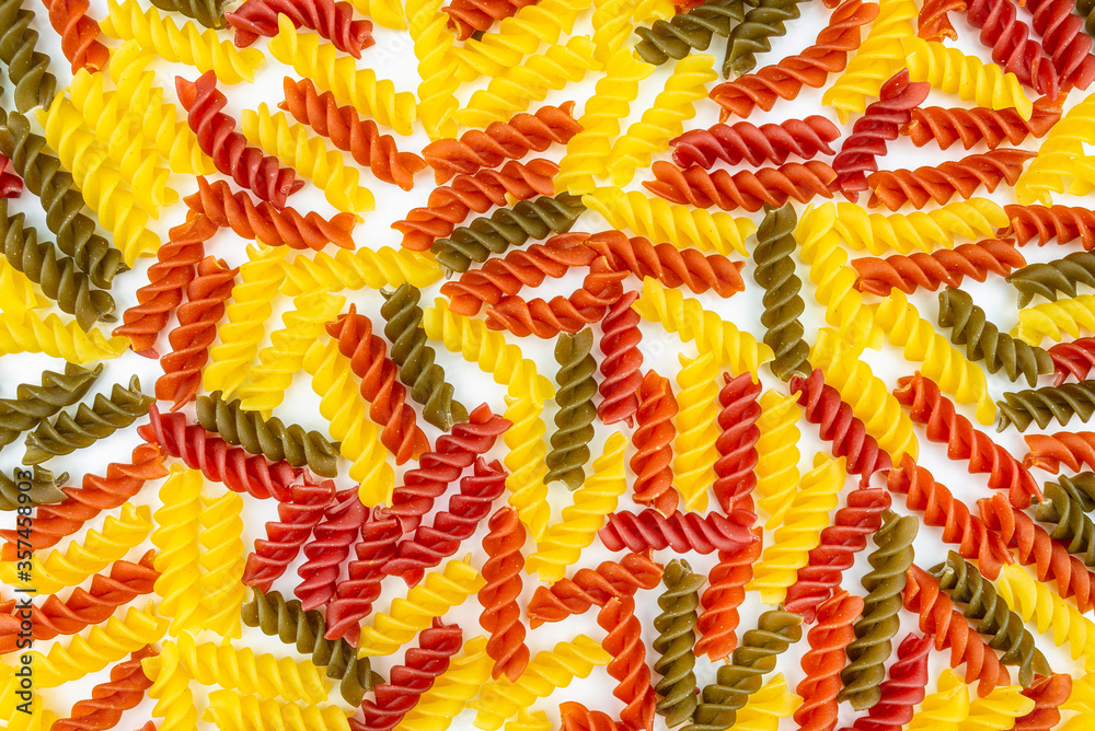 Background made of many colorful spiral macaroni lying on white ...