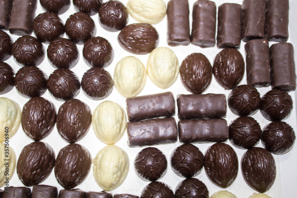 Chocolate candies of different shapes. chocolate pralines on white ...