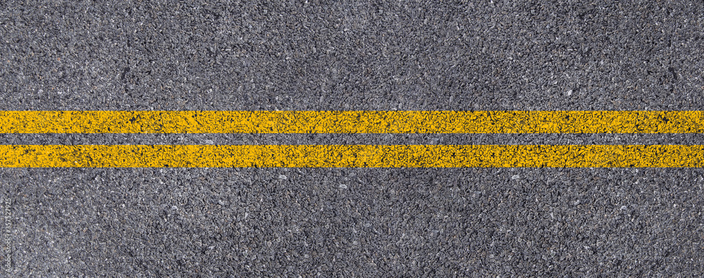 Top view of Double yellow lines on asphalt street roadway surface ...