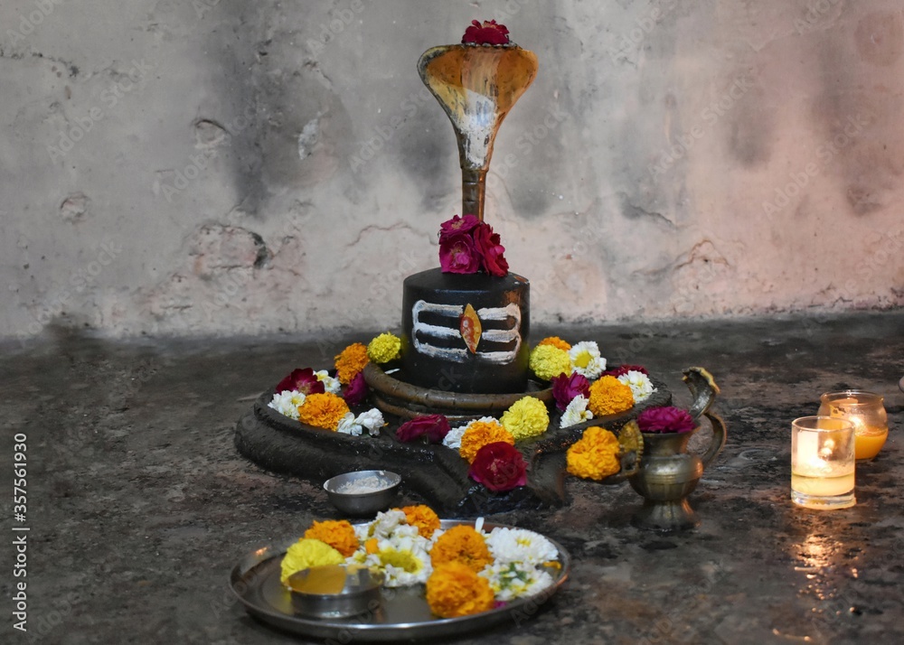 shiva shivling with flowers in a hindu temple Stock Photo | Adobe Stock