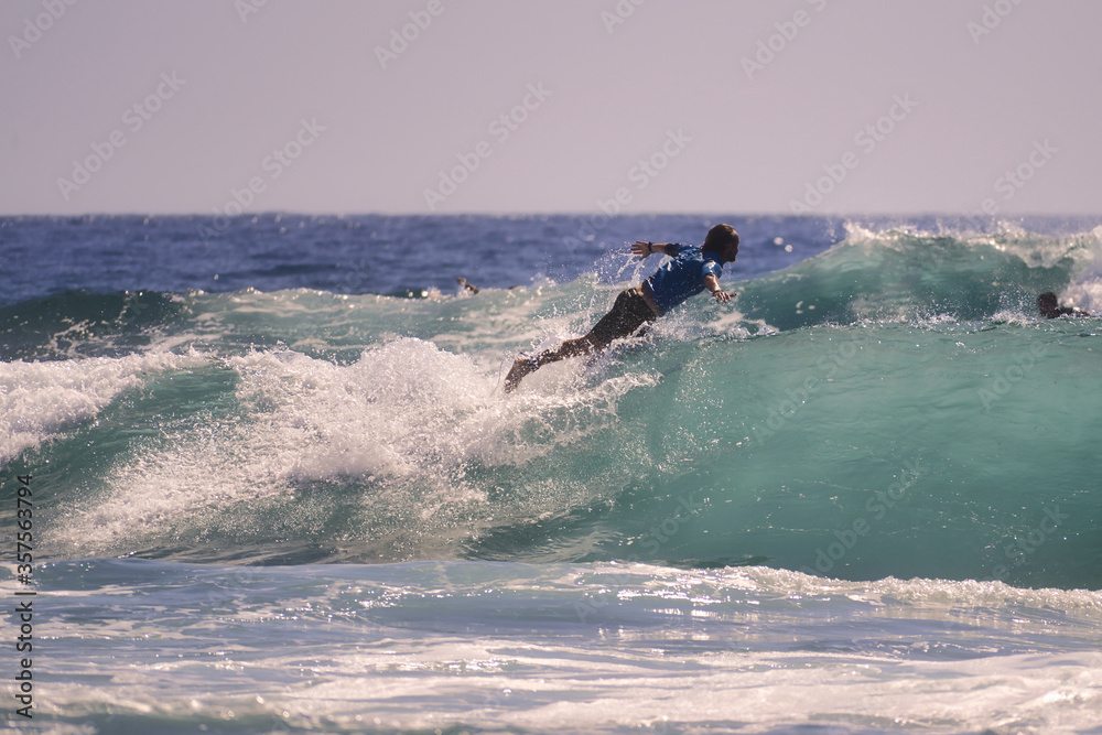 surfer goes to ride the waves Stock Photo | Adobe Stock