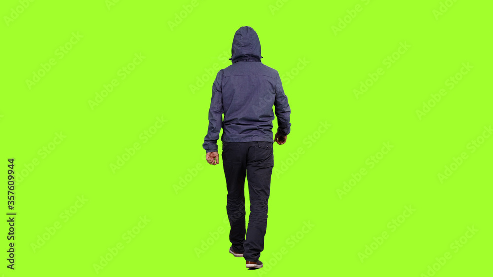 Back view of a hooded man walks on green screen background, Chroma ...