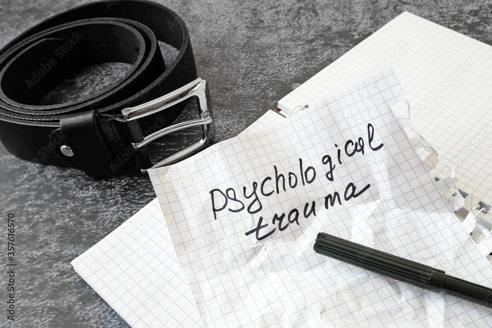 notebook with psychological trauma inscription and dark leather male ...