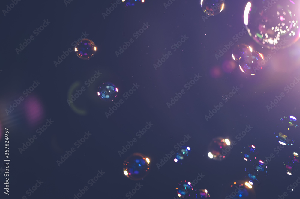 bubble foam on black background with abstract light flares background ...