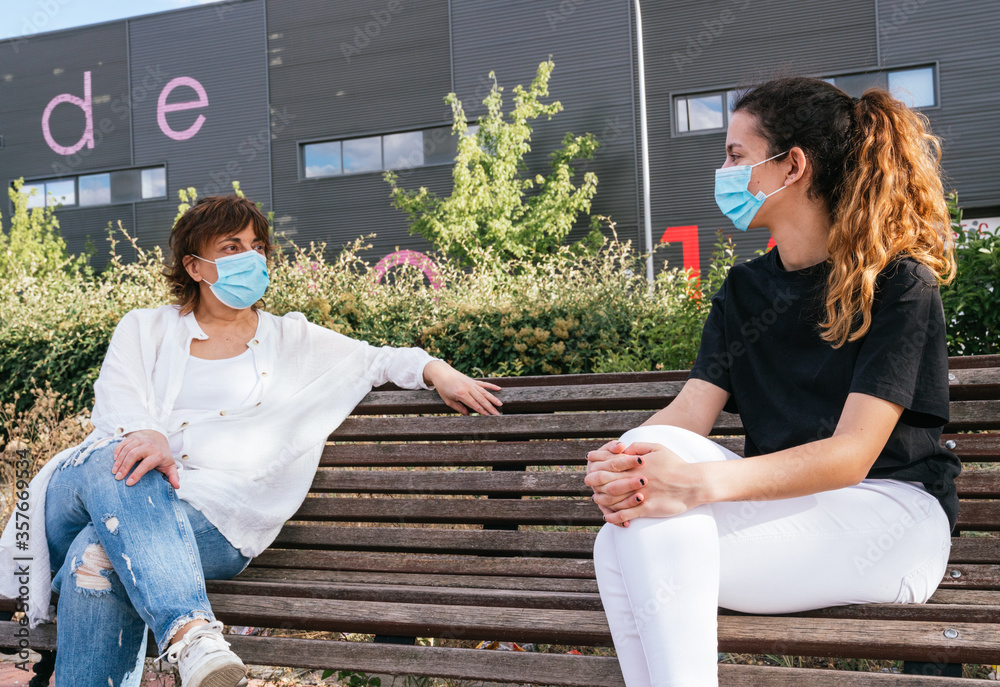 New normal. Social distance. Mother and daughter in social distance ...