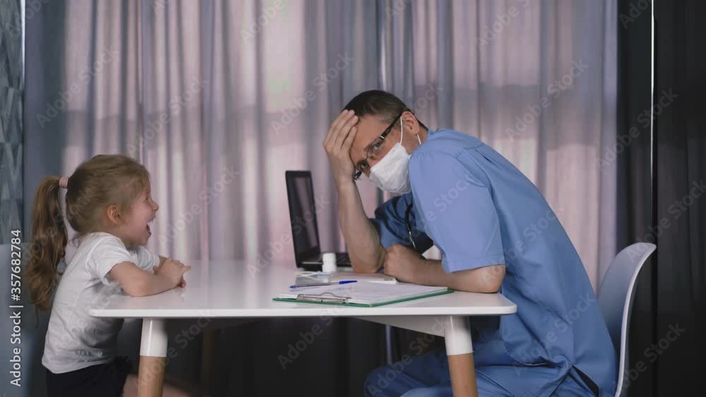 little girl, during doctor's advice, shows throat to pediatrician, doc ...