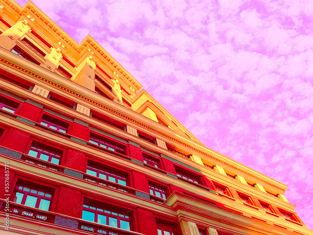 Contemporary collage. View of an orange building on a background of ...