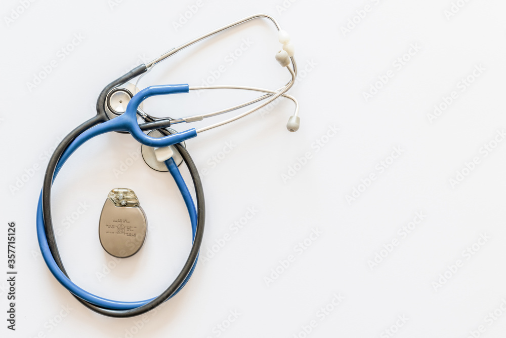 two blue and black stethoscopes on a white background with pacemaker ...
