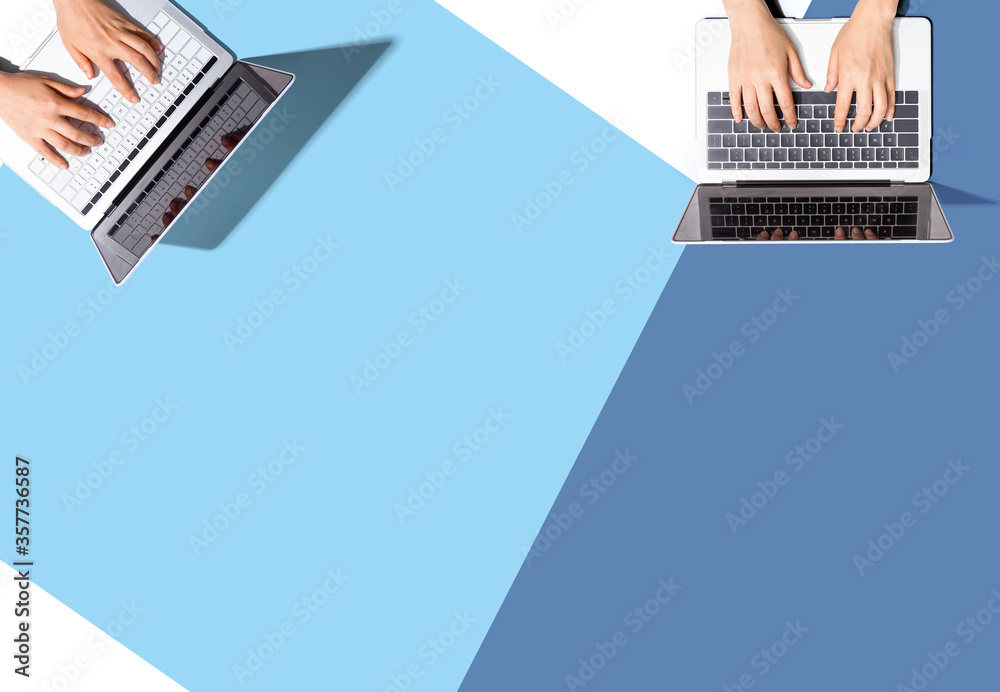 Two people working together with laptop computers Stock Photo | Adobe Stock