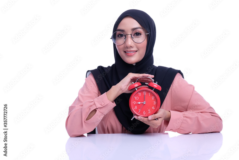 Muslim woman hold alarm clock with deference expression face with ...