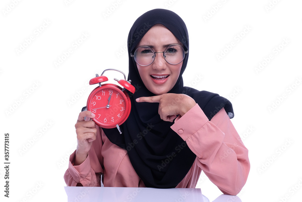Muslim woman hold alarm clock with deference expression face with ...