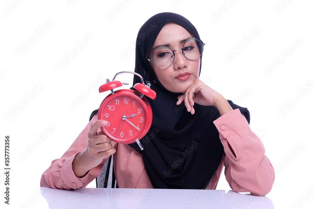 Muslim woman hold alarm clock with deference expression face with ...