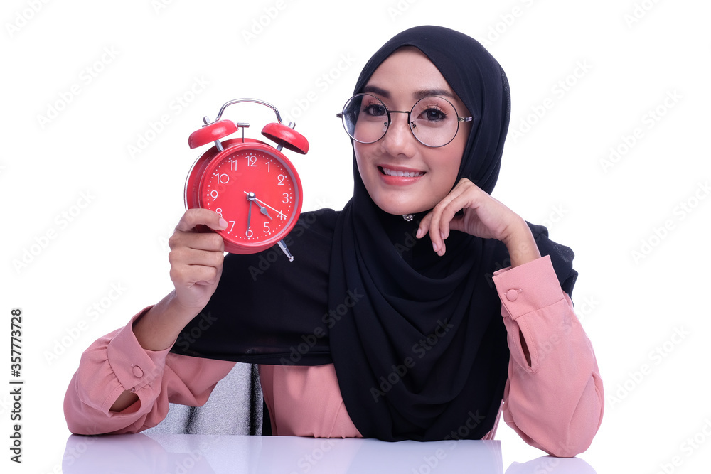 Muslim woman hold alarm clock with deference expression face with ...