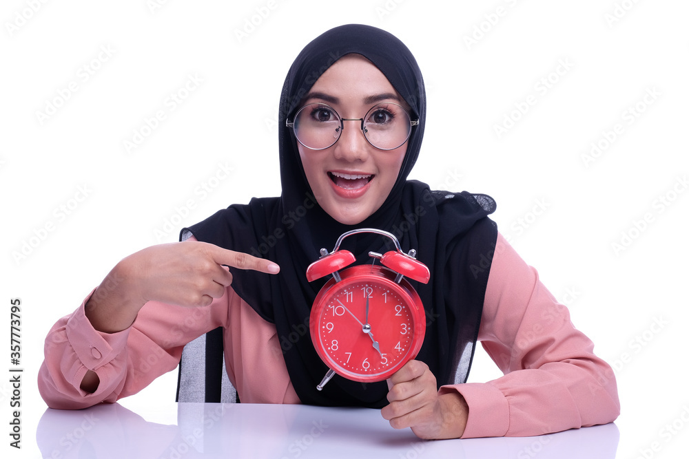 Muslim woman hold alarm clock with deference expression face with ...