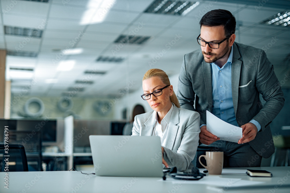 Manager assessing work of an employee, portrait. Stock Photo | Adobe Stock