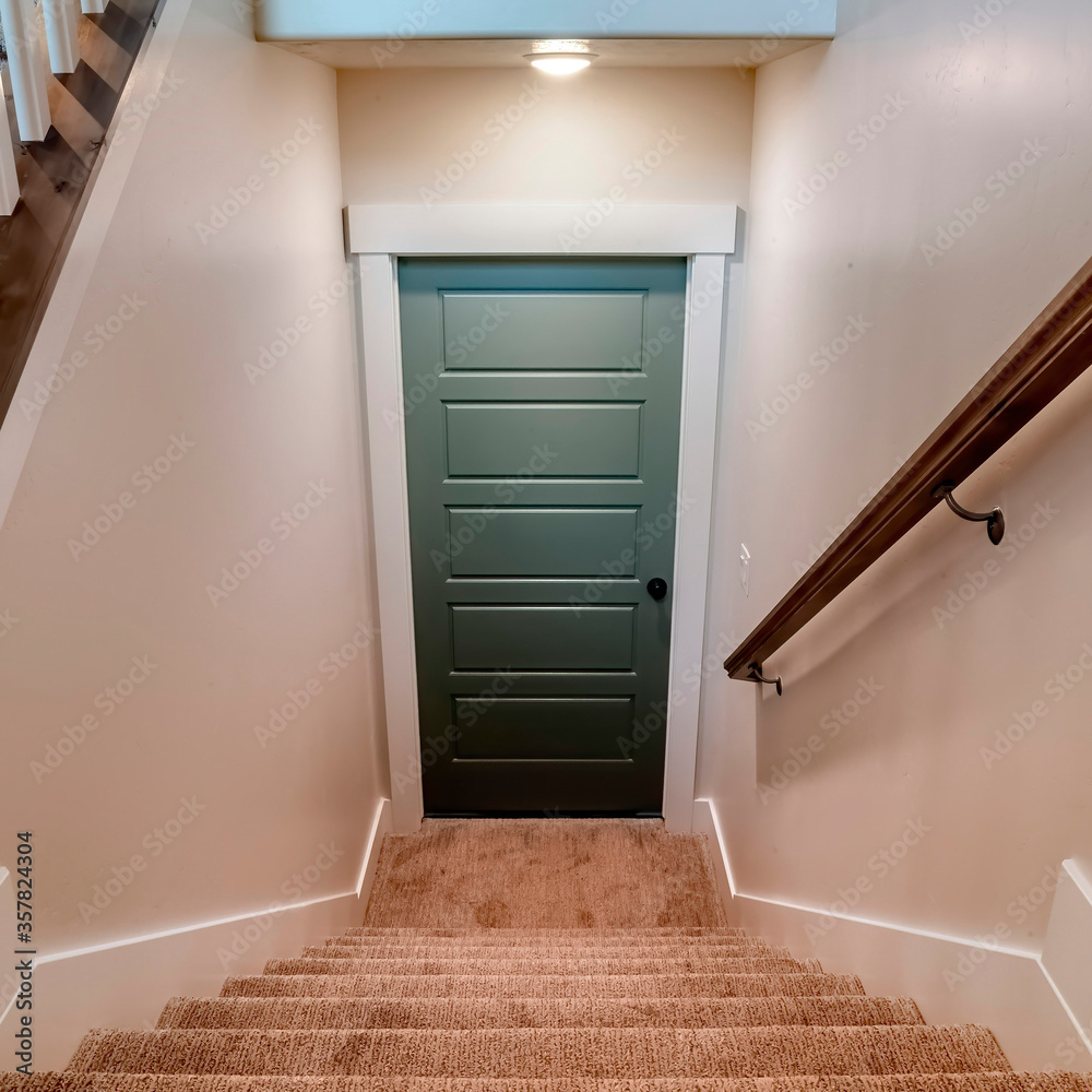 Square U shaped staircase that leads to the basement door from main ...