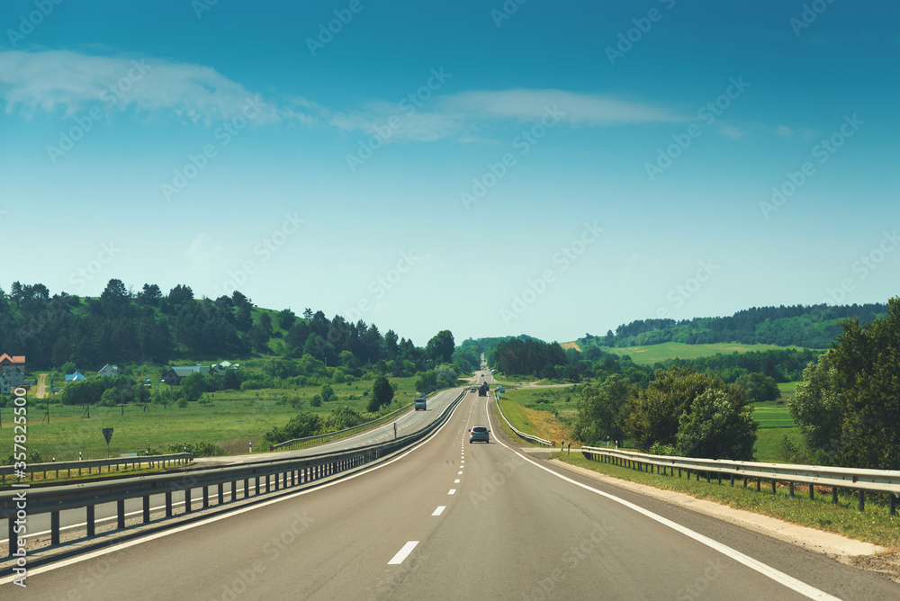 Traffic in high speed on a highway through summer landscape. Stock ...