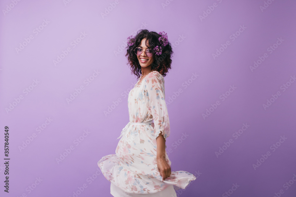 Fascinating african girl with flowers in hair posing in studio ...