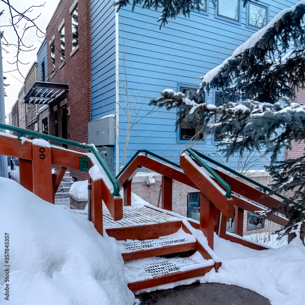 Square Oudoor stairs with grate metal treads and green handrails ...