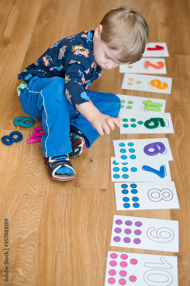 Early mathematic. Little boy playing with numbers and dot cards. Home ...