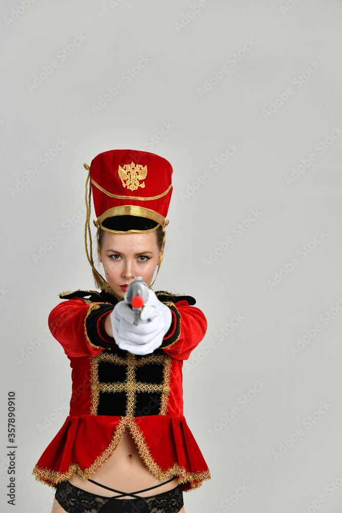beautiful girl in an old hussar costume and in black boots and with a ...