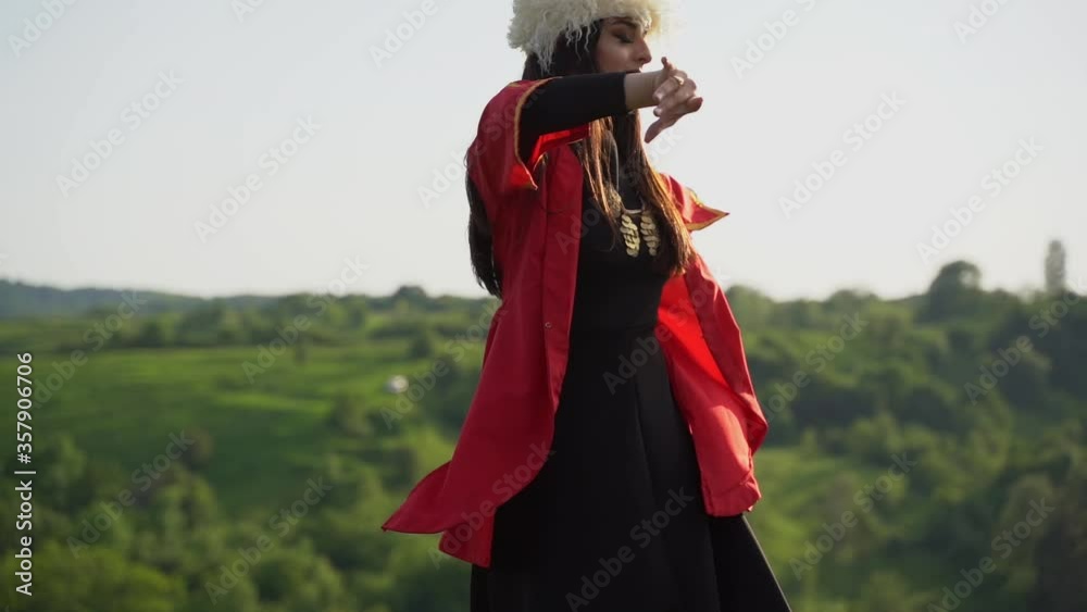 Georgian girl in white papakha and red national dress dances national ...