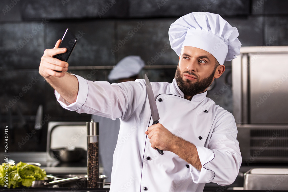 Professional chef make photo. Portrait of male chef with knife taking ...