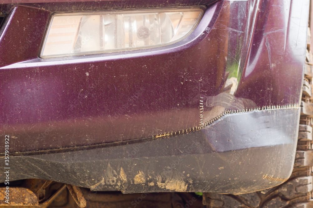 Stitched front bumper of the SUV. Stitches with nylon thread or fishing ...