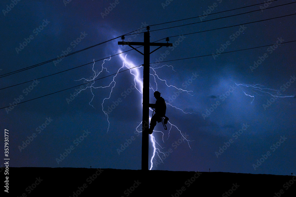 Lineman working in Lightning Storm Stock Photo | Adobe Stock