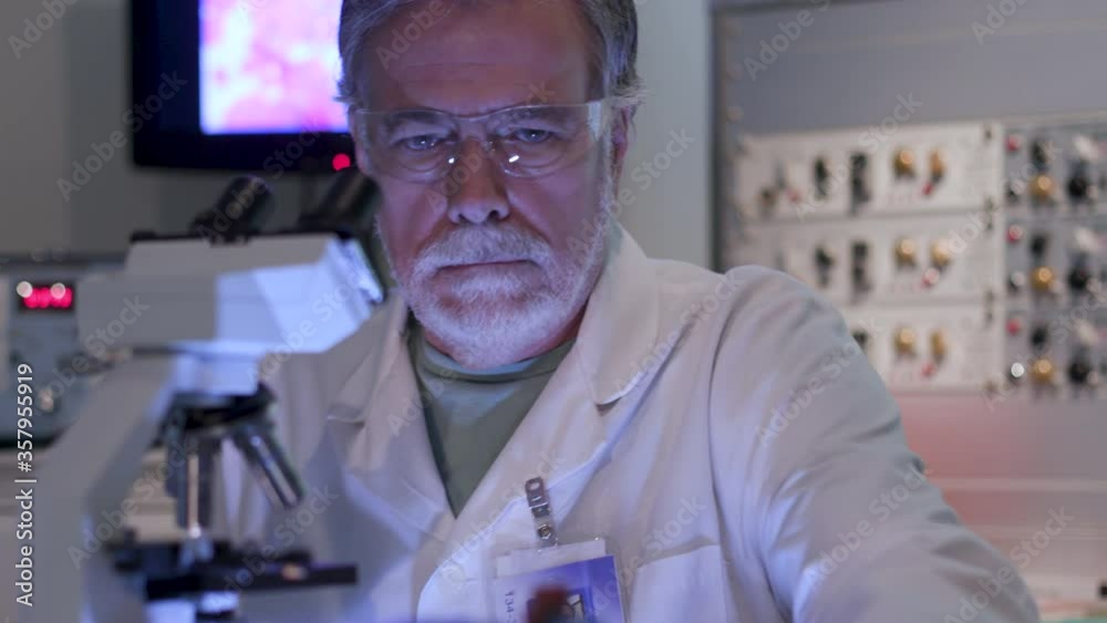 Out of focus cancer cells on a monitor in the background of this ...