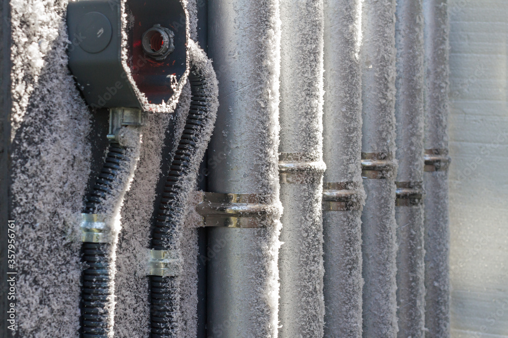 The frosted industrial refrigeration compressor pipeline. Frozen ball ...