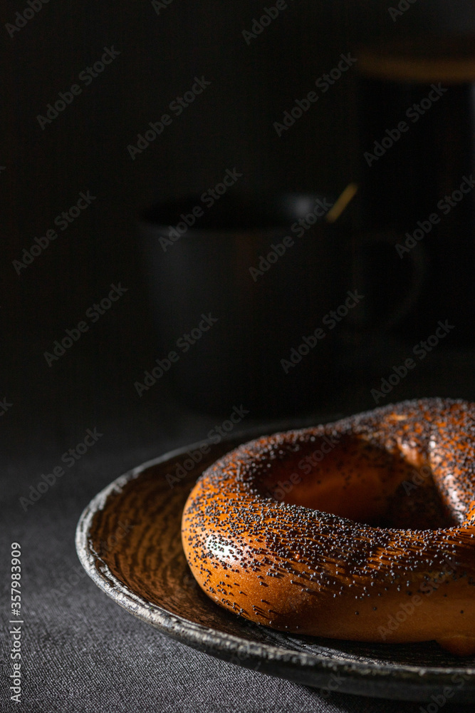 Ring shaped roll | Bagel with poppies on the top served in the dark ...