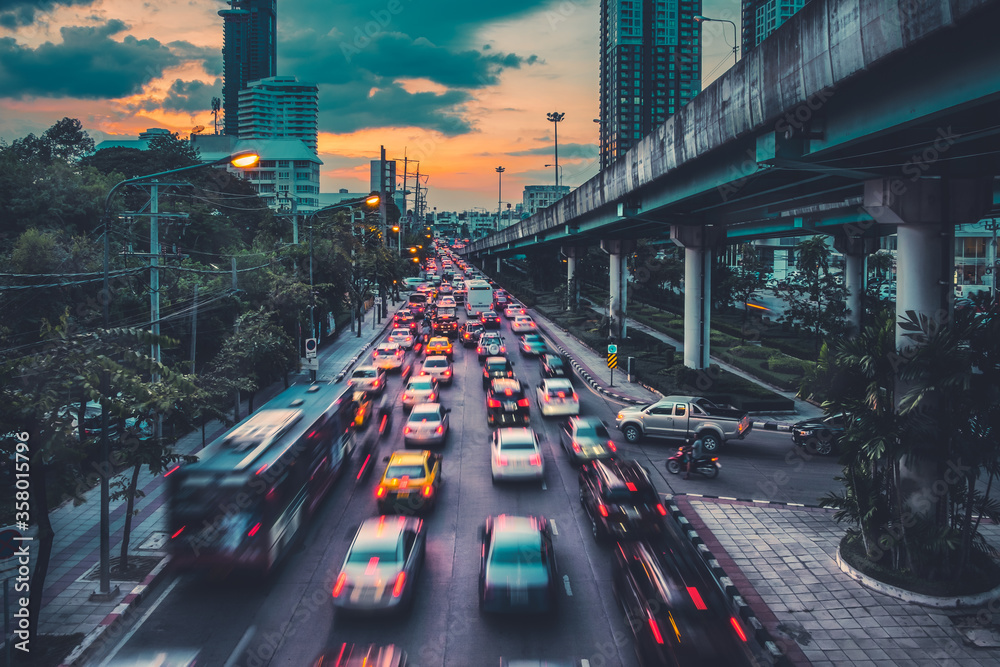 Car lights at evening on the road going to the city. Aerial view of the ...
