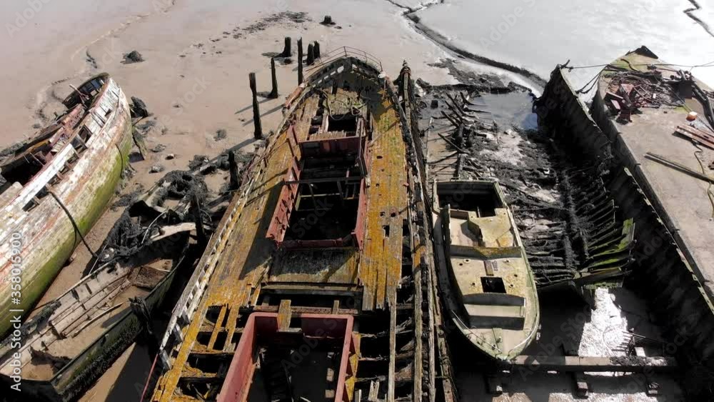 Old broken Wooden Ships Abandoned On The Shore stuck in the mud at ...