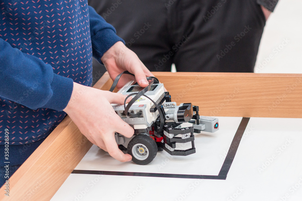Minsk, Belarus. March, 2018. Boys construct and code robots. Lego ...