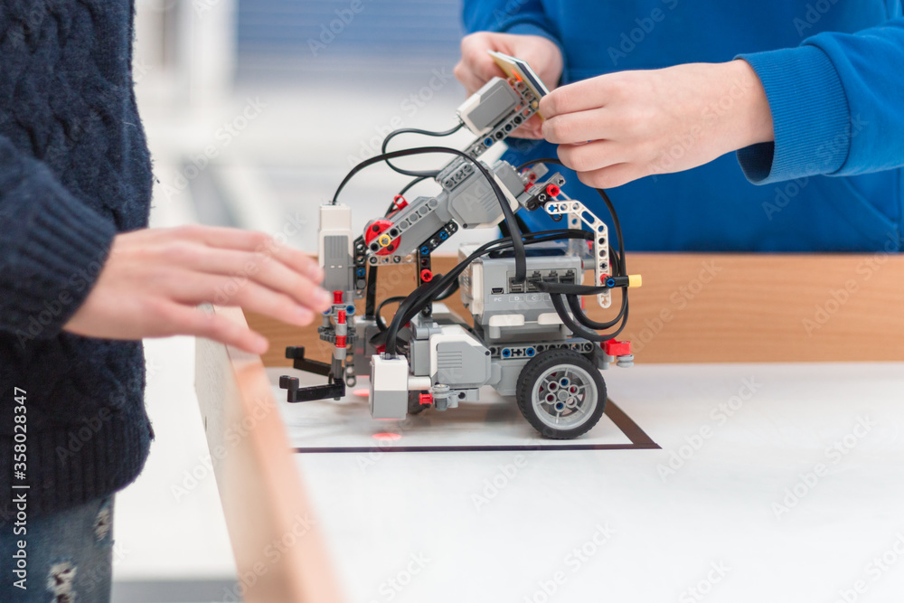 Minsk, Belarus. March, 2018. Boys construct and code robots. Lego ...