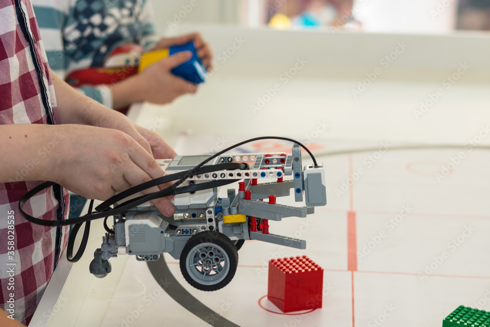 Minsk, Belarus. March, 2018. Boys construct and code robots. Lego ...