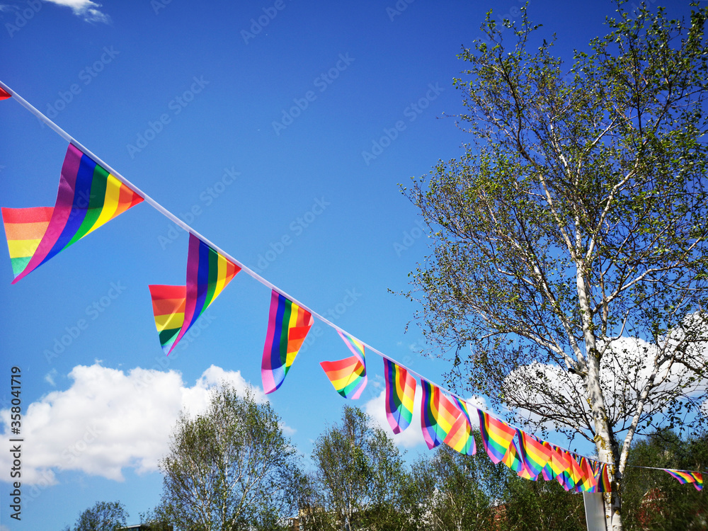 Rainbow Flags at a Gay Pride Parade hung from a tree with vibrant ...