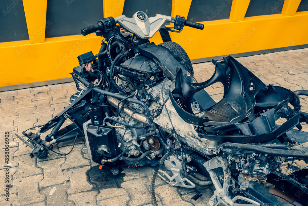 Vehicle, tricycle, after an accident. A burned motorcycle near the ...