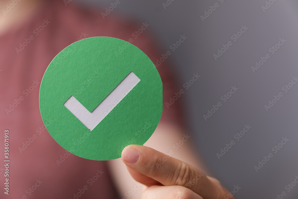 hand holding green checkmark Stock Photo | Adobe Stock