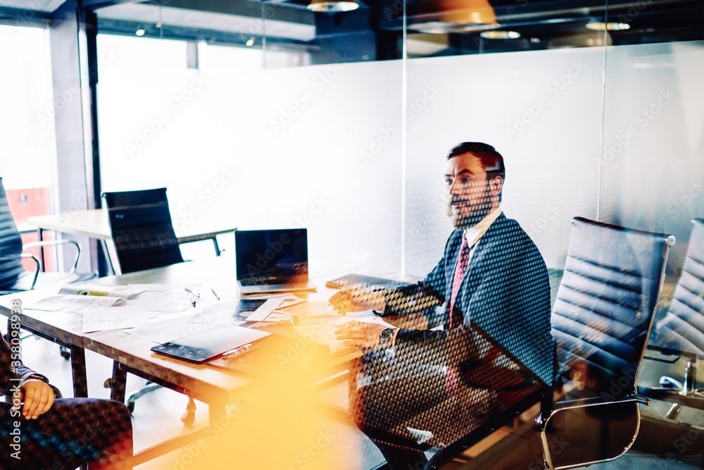 Experienced corporate male director sitting in chair at his cabinet ...