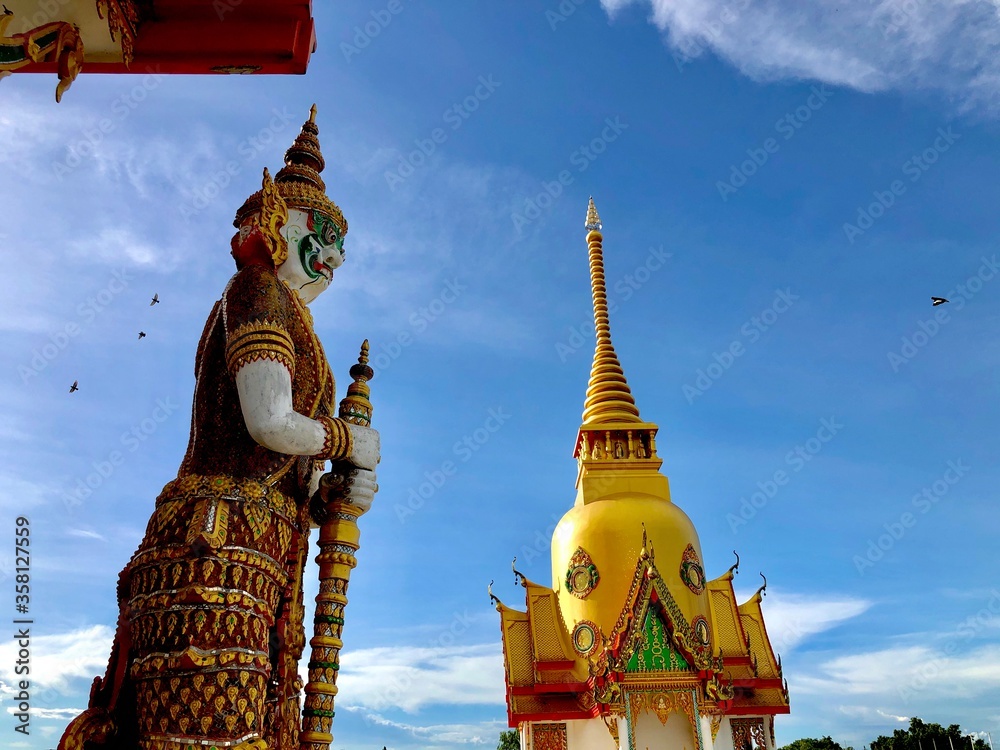Giant guarding the Thai temple gate.Standing around the temple to ...