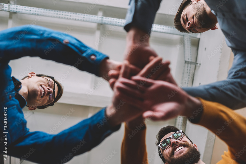 Group of successful male partners celebration win and stacking hands ...