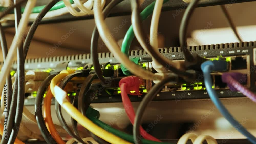 Network switch and ethernet cable in rack cabinet. Network connection ...