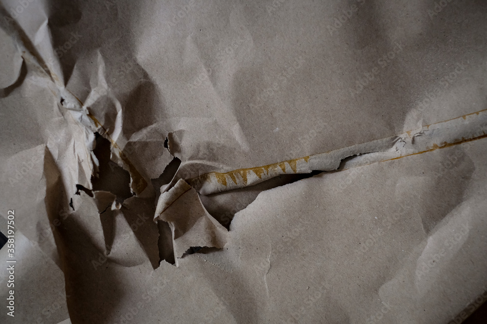 Crumpled, torn cardboard paper. Broken, crinkled brown paper with beige ...