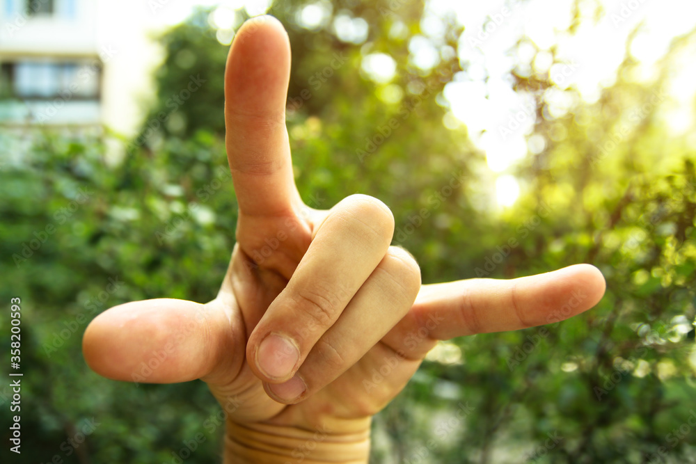 Heavy metal hand shows the symbol of Rock. Music background for fans ...