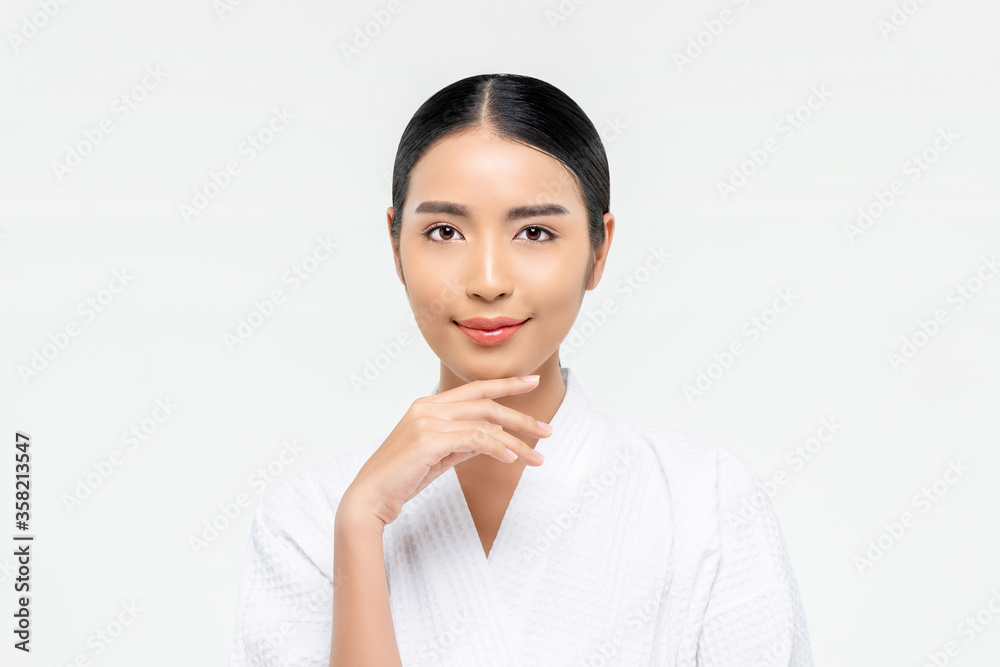 Smiling beautiful Asian woman model in spa attire with clear fair skin ...