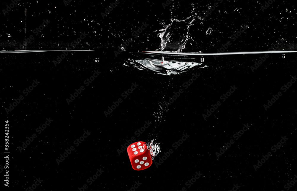 Ludo dice in water splash on black background with lots of air bubbles ...